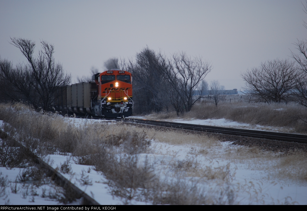 BNSF 6372 makes the turn with her SD-70MAC DPU in the background as they roll north with a mty ...